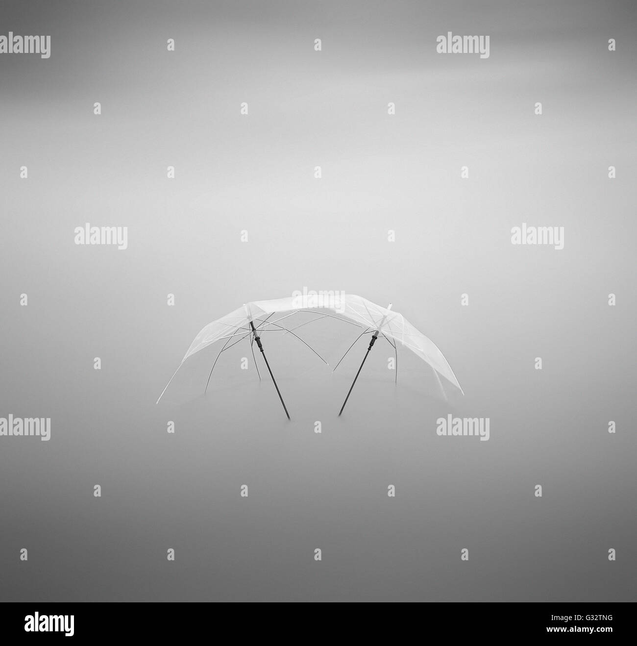 Two umbrellas in sea Stock Photo - Alamy