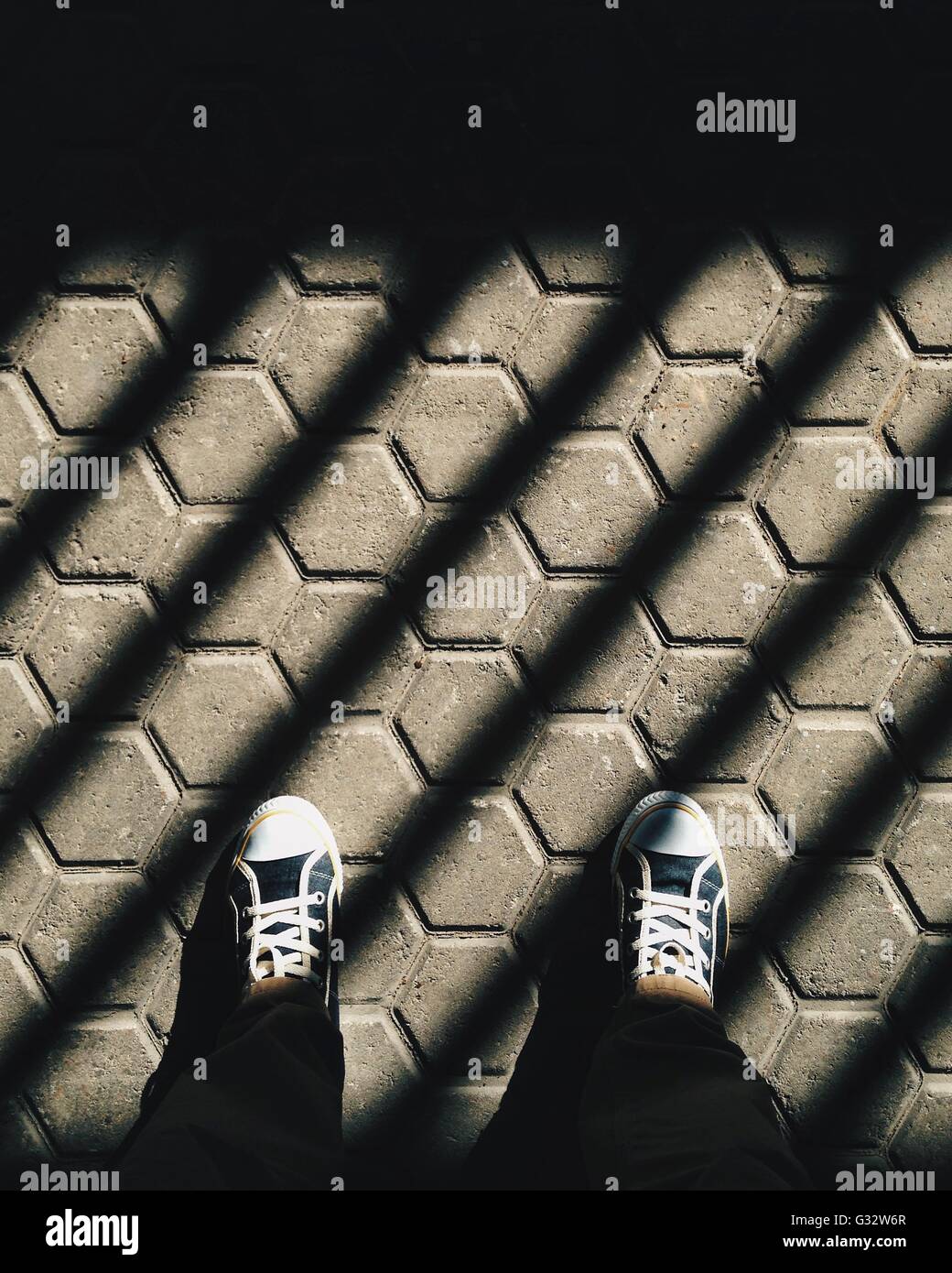 Man's feet in shadows Stock Photo - Alamy
