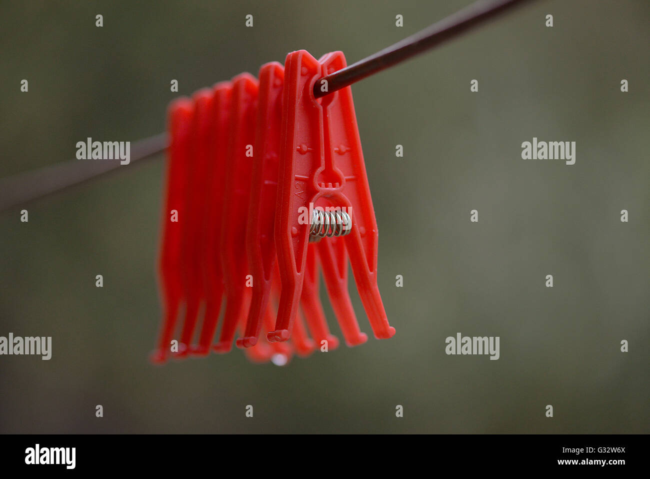 Clothes pegs hanging on washing line Stock Photo - Alamy