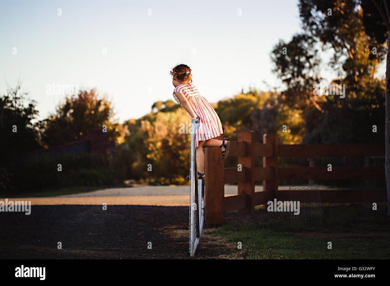 Girl on gate hi-res stock photography and images - Alamy