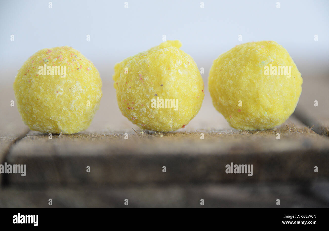 Three white chocolate truffles in a row Stock Photo - Alamy