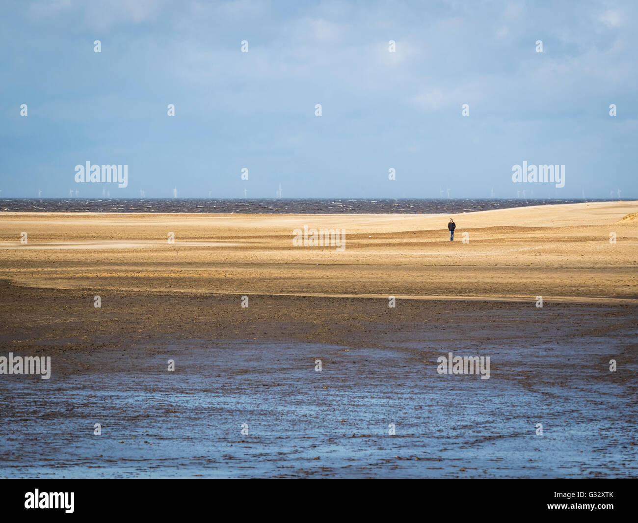 Lone person on sandy beach Stock Photo - Alamy