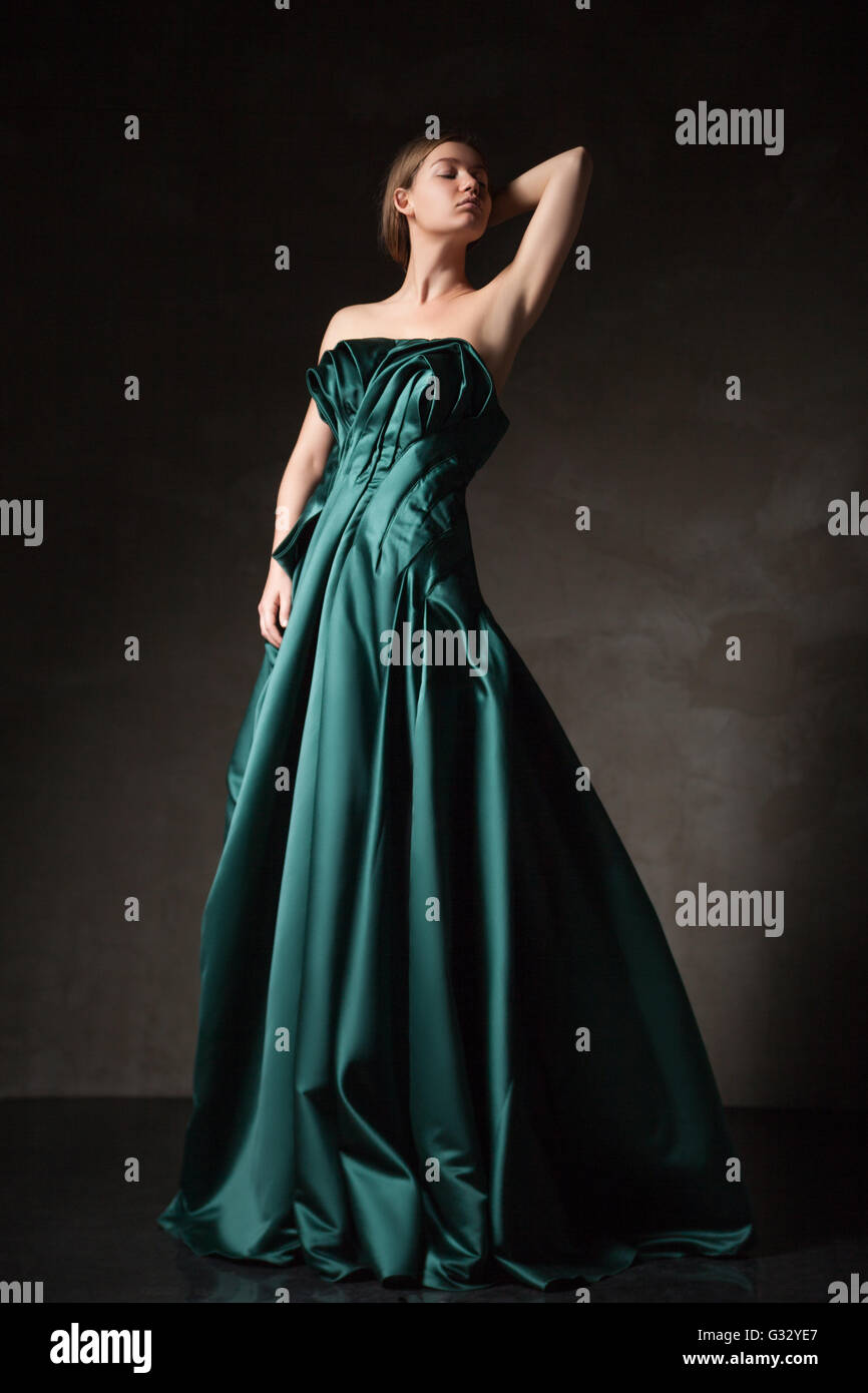 Model posing in green fashion dress Stock Photo - Alamy