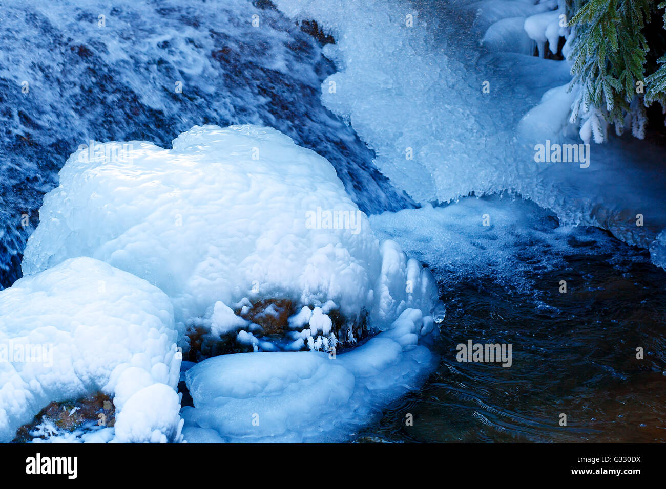 Winter scene with water falling from icy rocks Stock Photo - Alamy