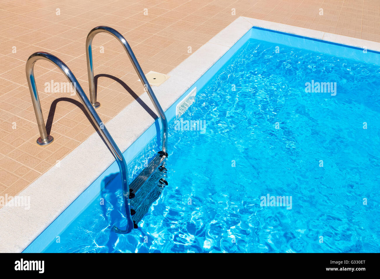 water in blue swimming pool with steps in summer season Stock Photo - Alamy