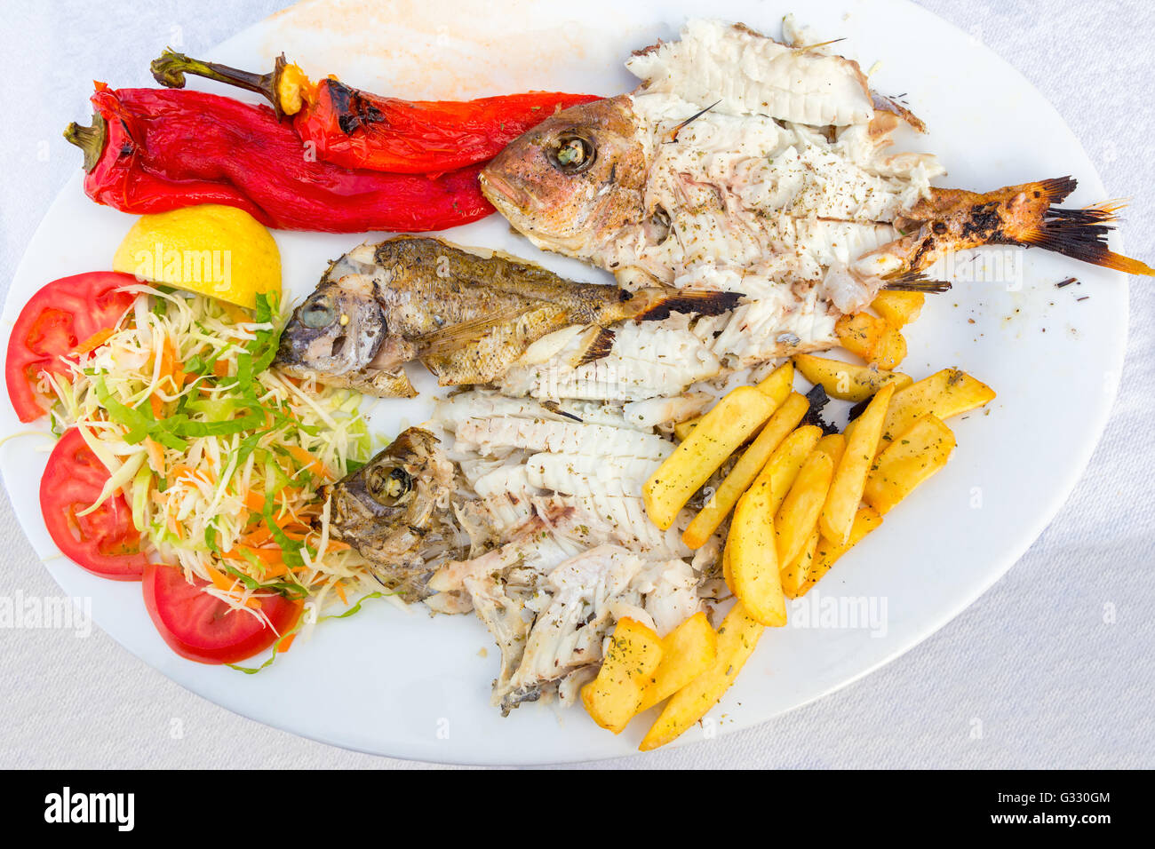 Mediterranean menu fish fries and vegetables on plate Stock Photo - Alamy