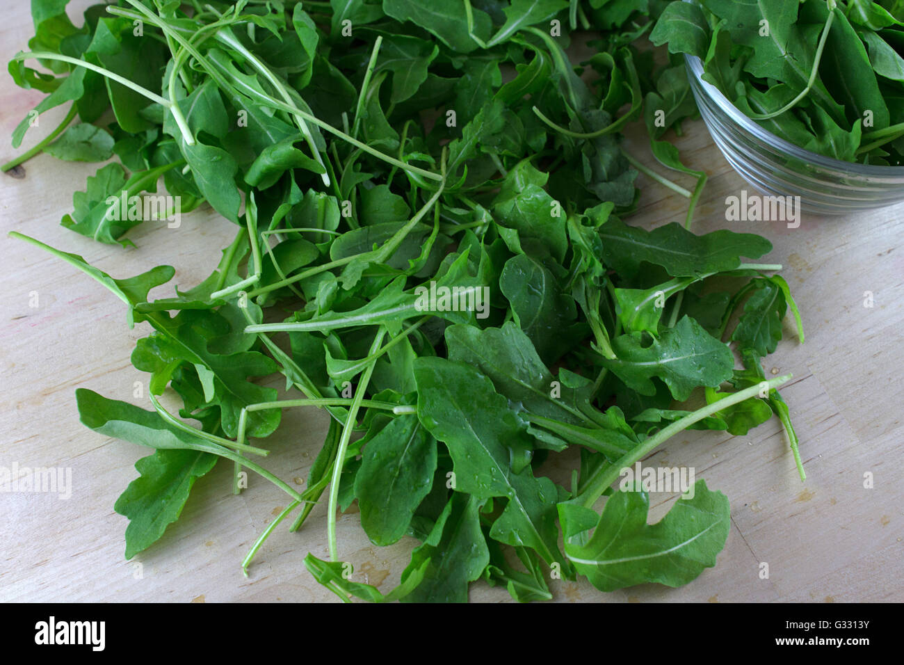 Wild rucola salad isolated on wooden background Stock Photo - Alamy