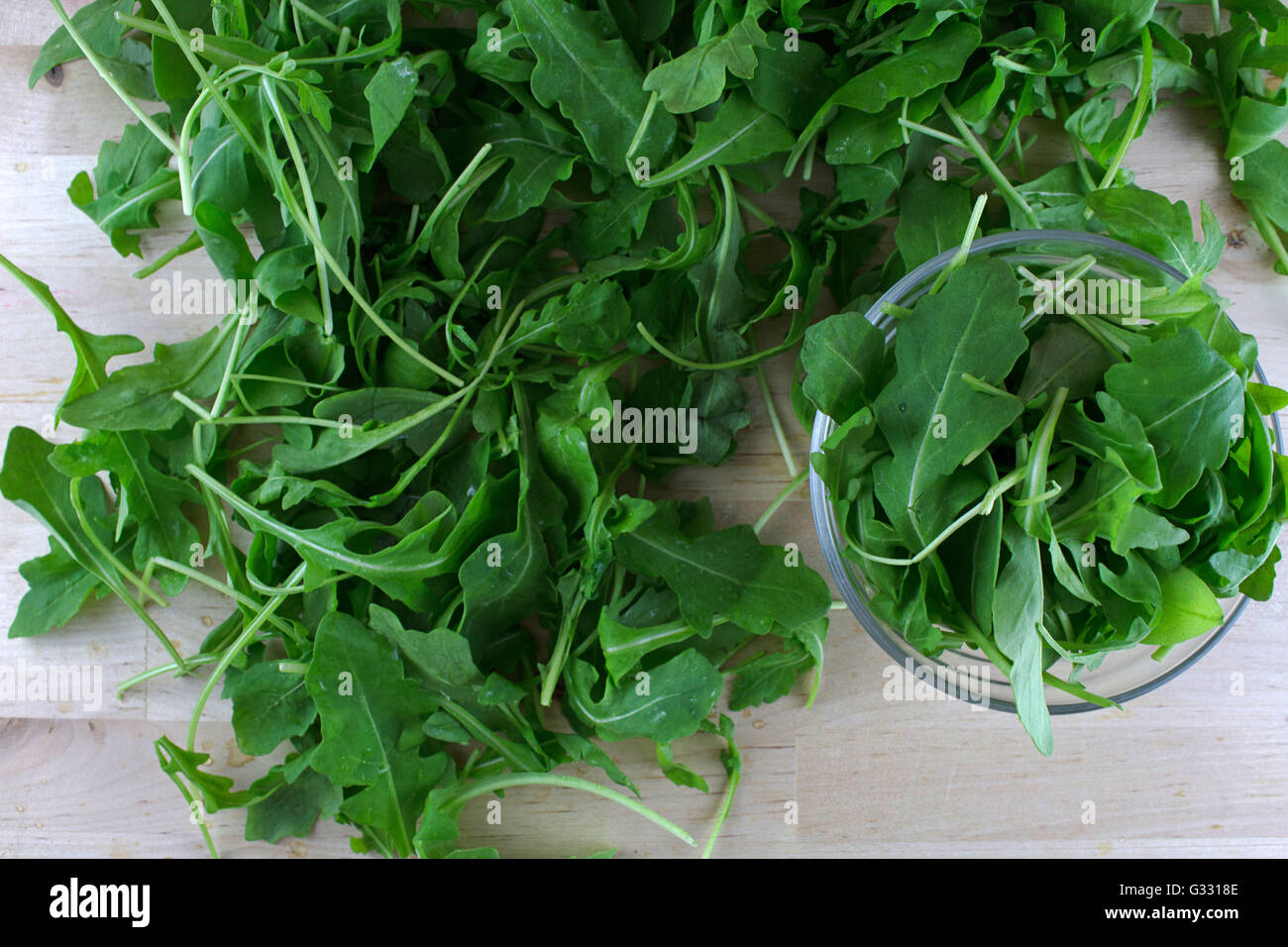 Wild rucola salad isolated on wooden background Stock Photo - Alamy