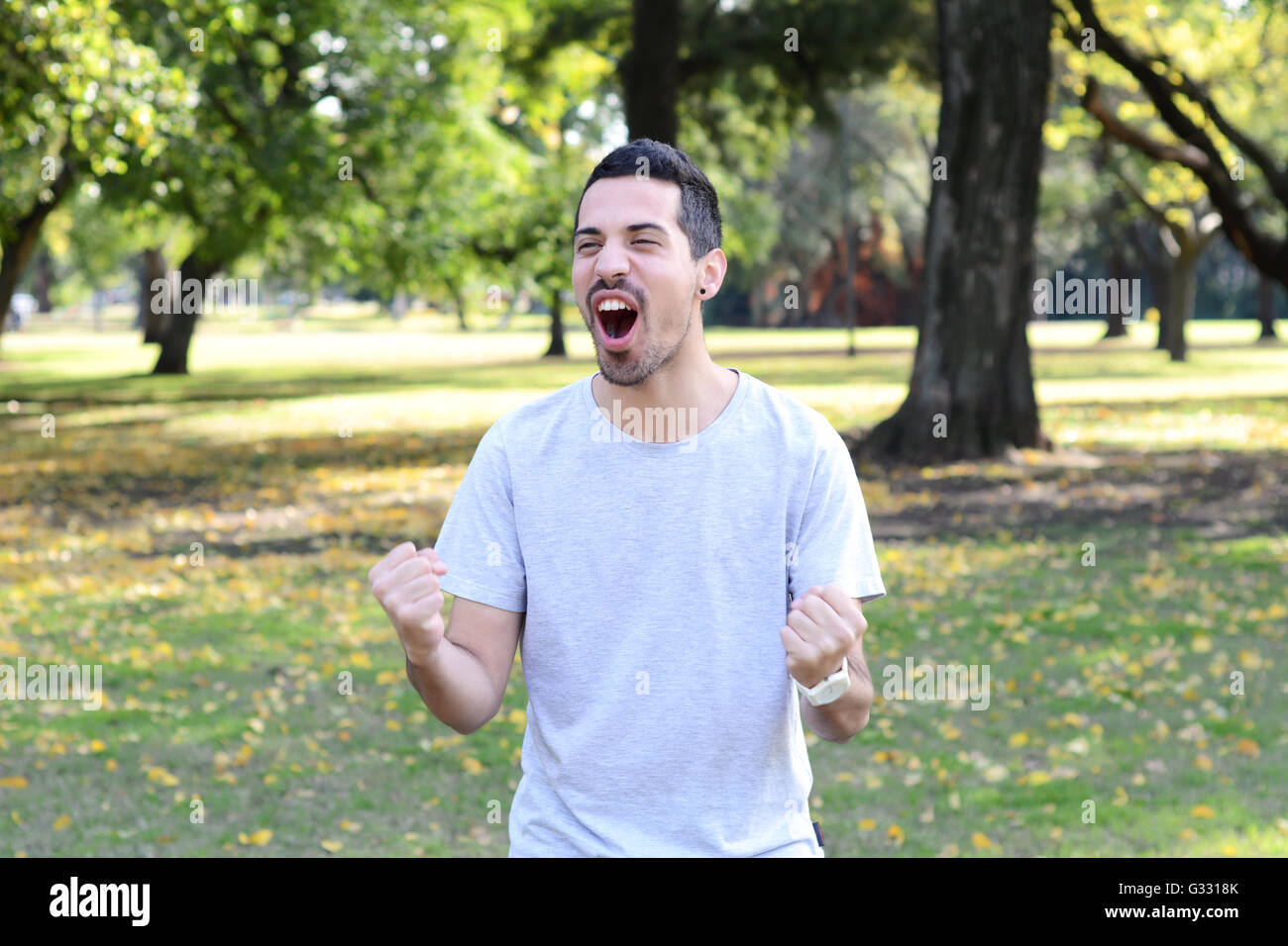Portrait of young latin man doing success gesture in a park. Outdoors ...