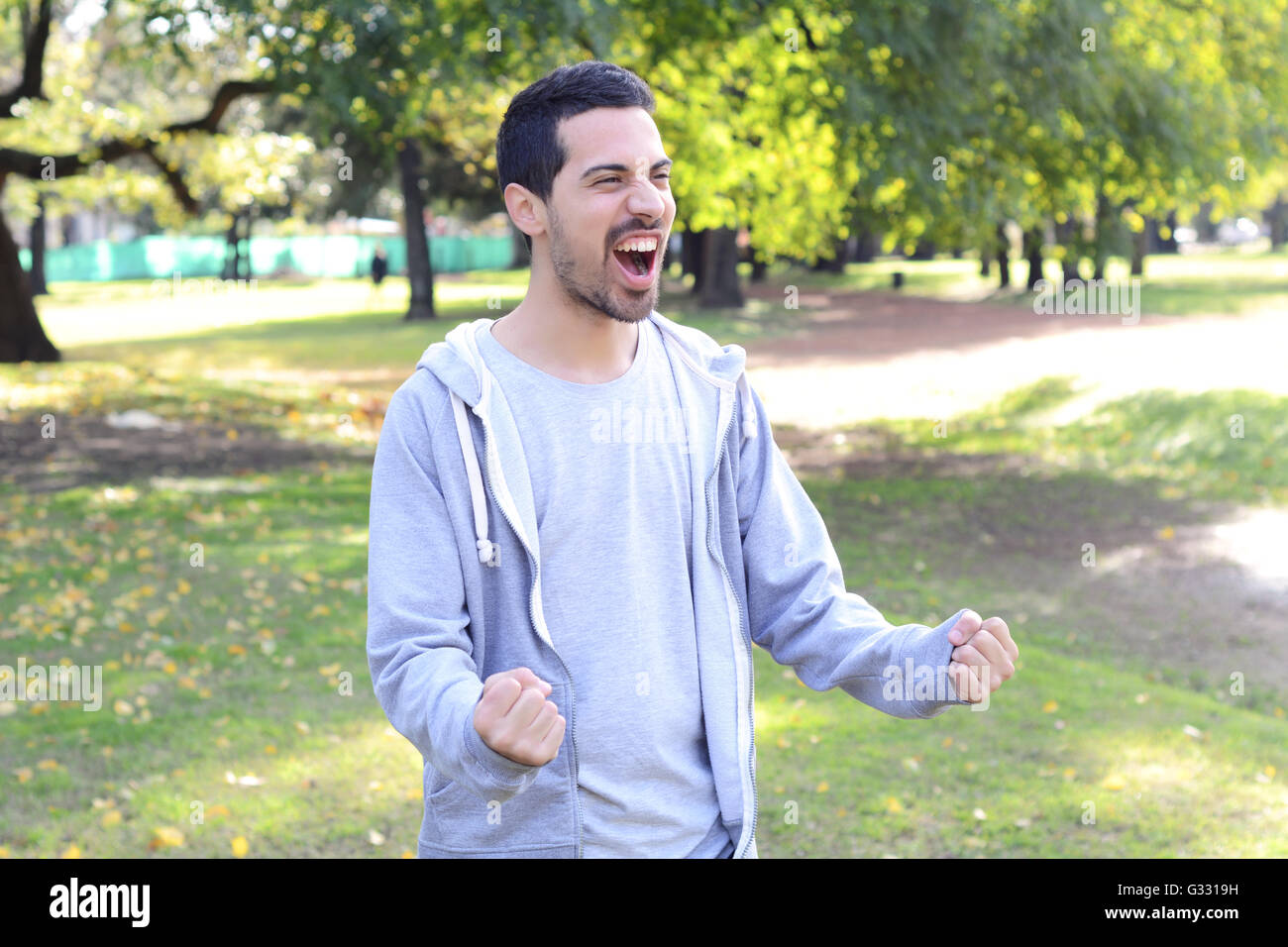 Portrait of young latin man doing success gesture in a park. Outdoors ...