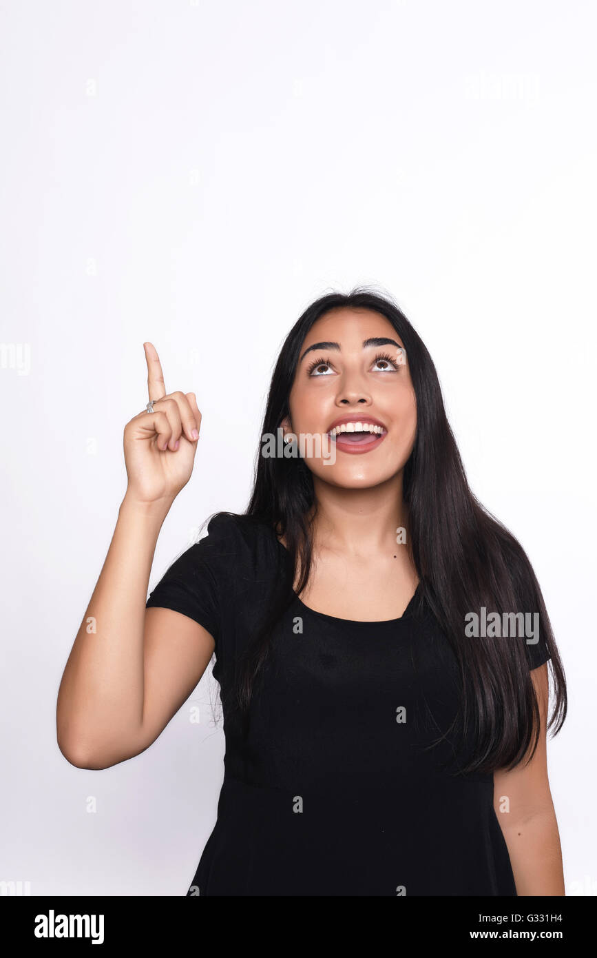 Young beautiful woman pointing at white background Stock Photo - Alamy