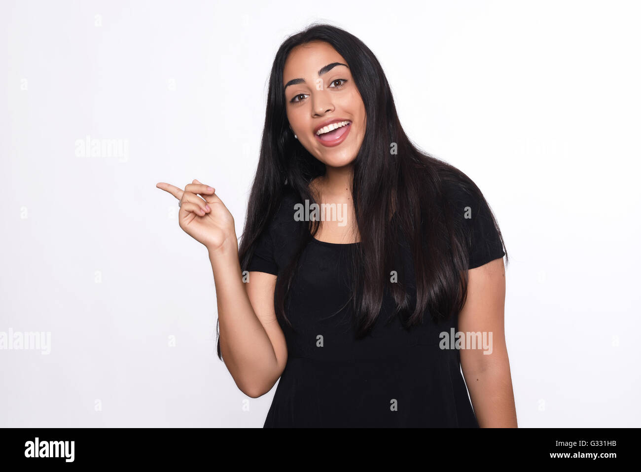Young beautiful woman pointing at white background Stock Photo - Alamy