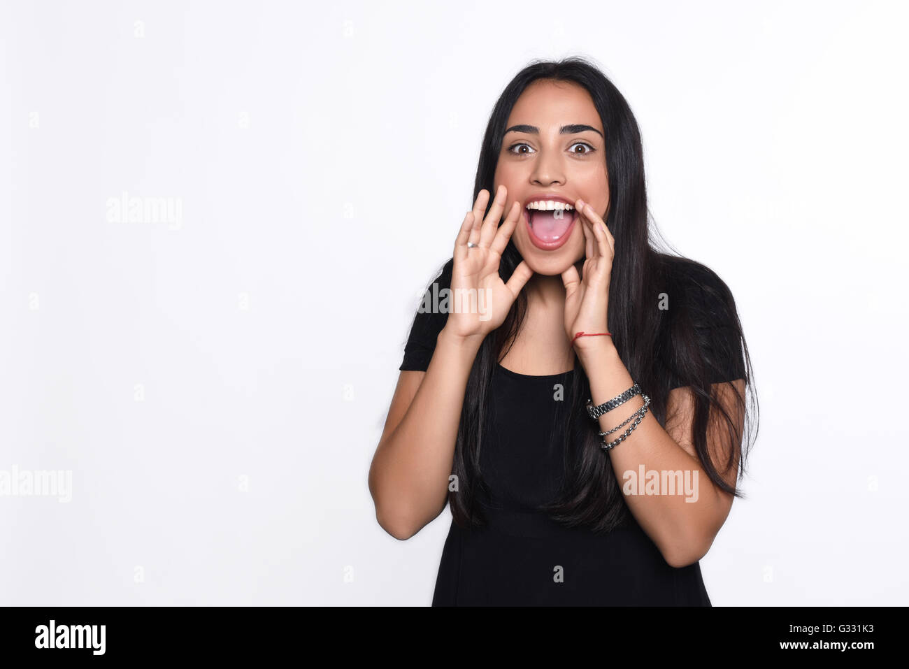 Beautiful young woman shouting and screaming. Isolated white background ...