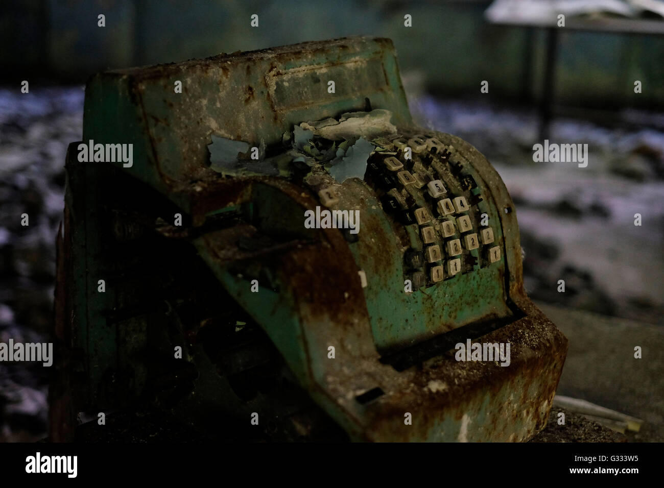 An old rusty cash register on the floor of an abandoned store in the ...
