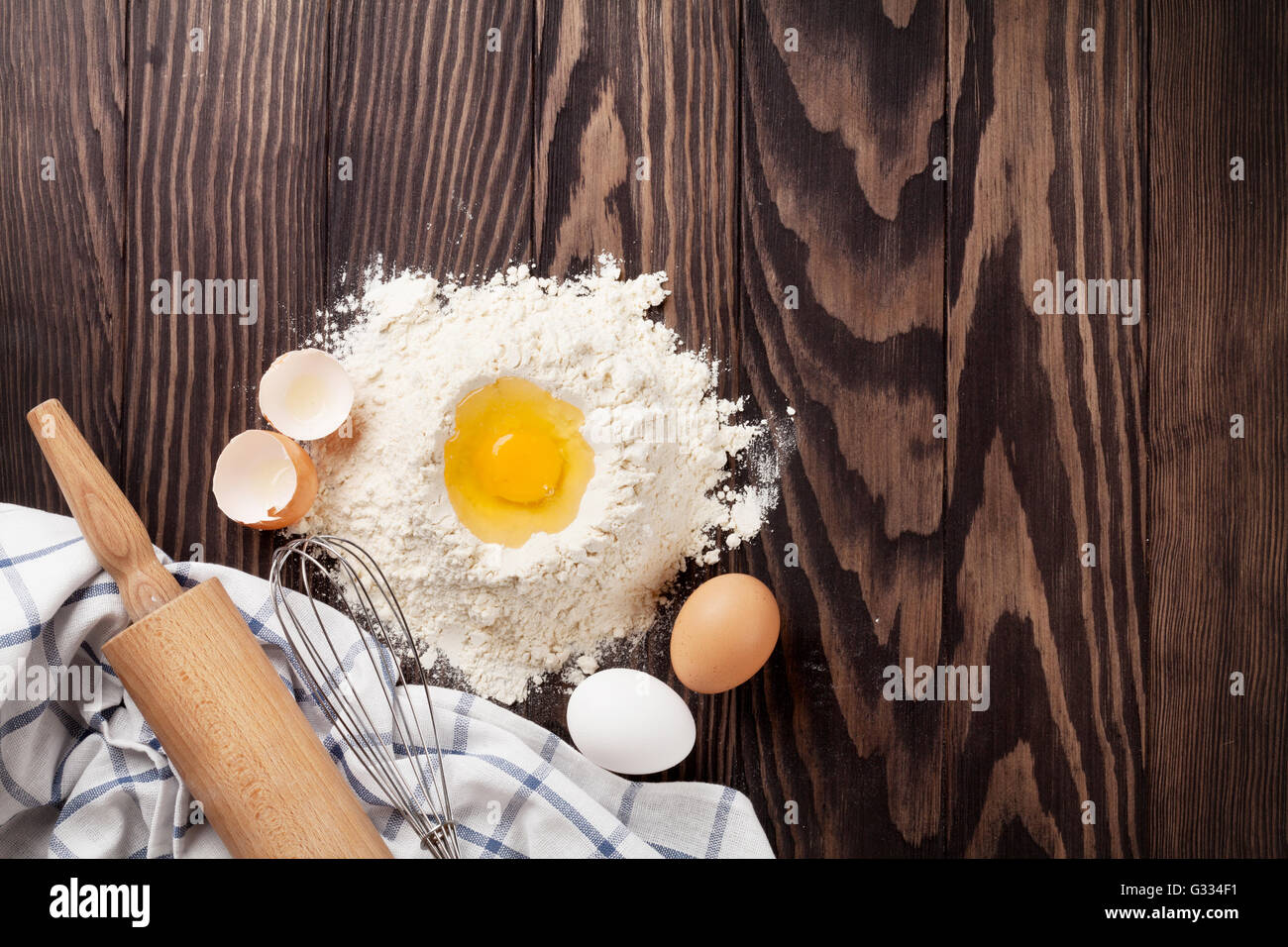 Kitchen table with utensils and ingredients. Top view with copy space ...