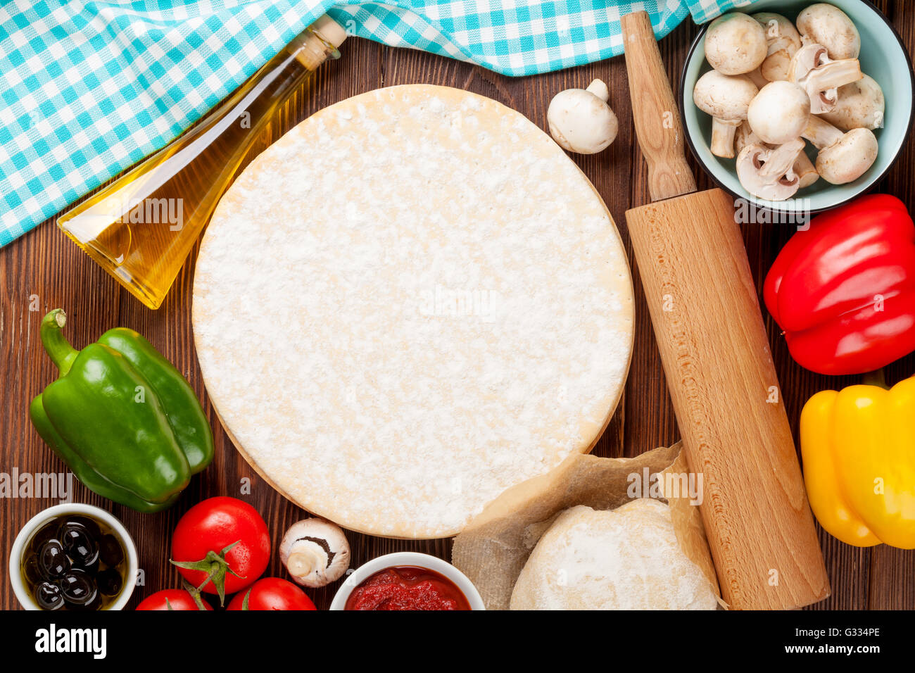 Pizza cooking ingredients. Dough, vegetables and spices. Top view with ...
