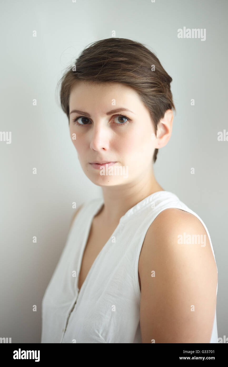 Charming short hair young woman without makeup on white background ...
