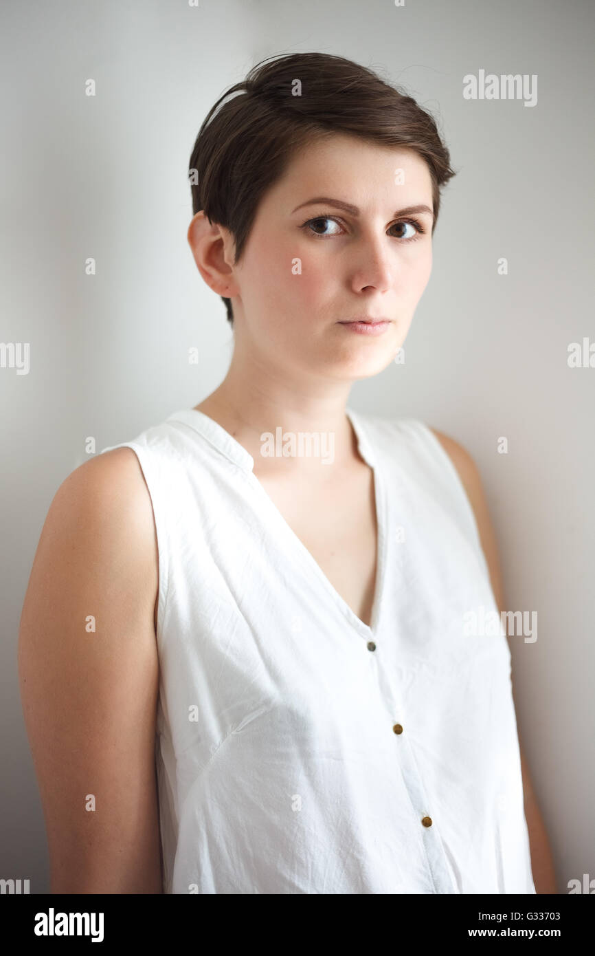 Charming short hair young woman without makeup on white background ...