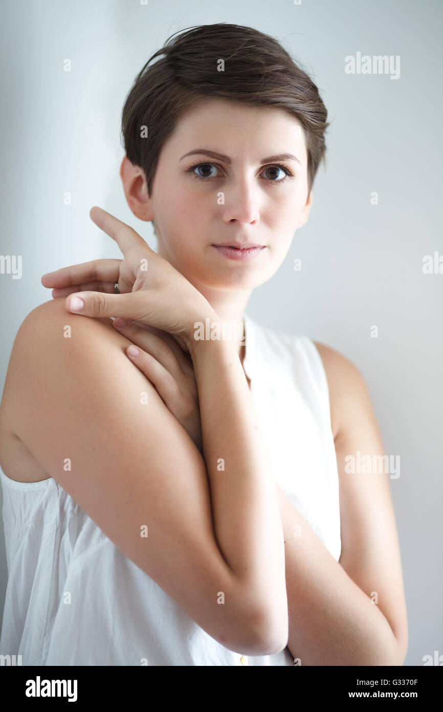 Charming short hair young woman without makeup on white background ...