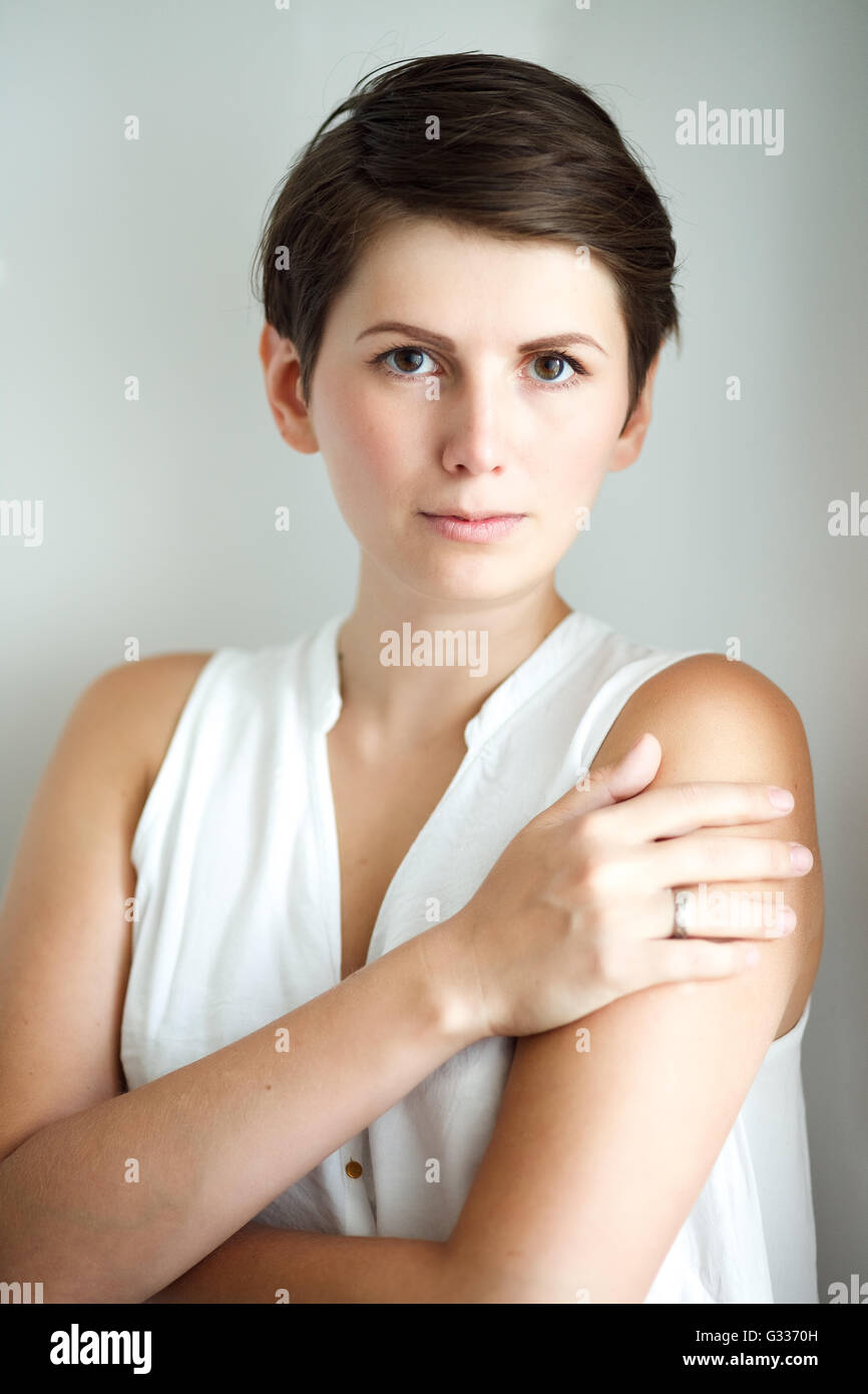 Charming short hair young woman without makeup on white background ...