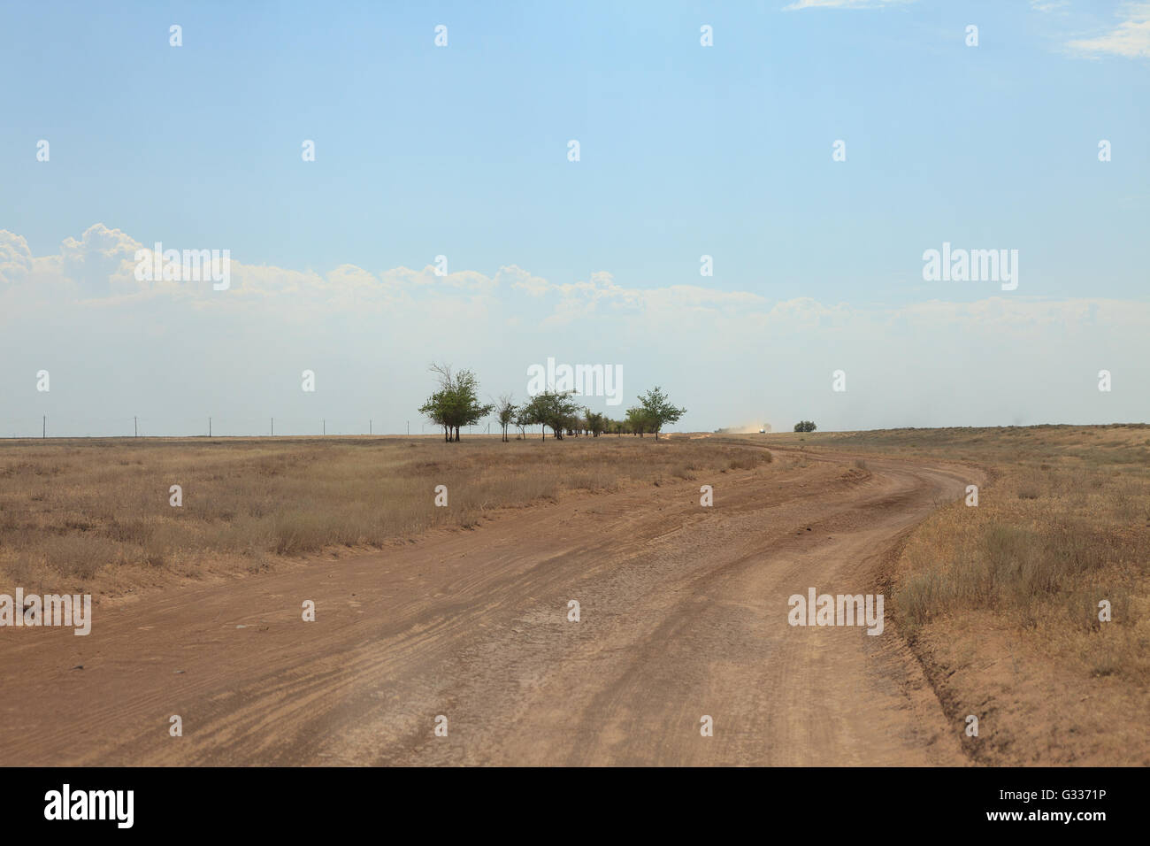 Sandy country road in the salt desert landscape on a hot summer day ...