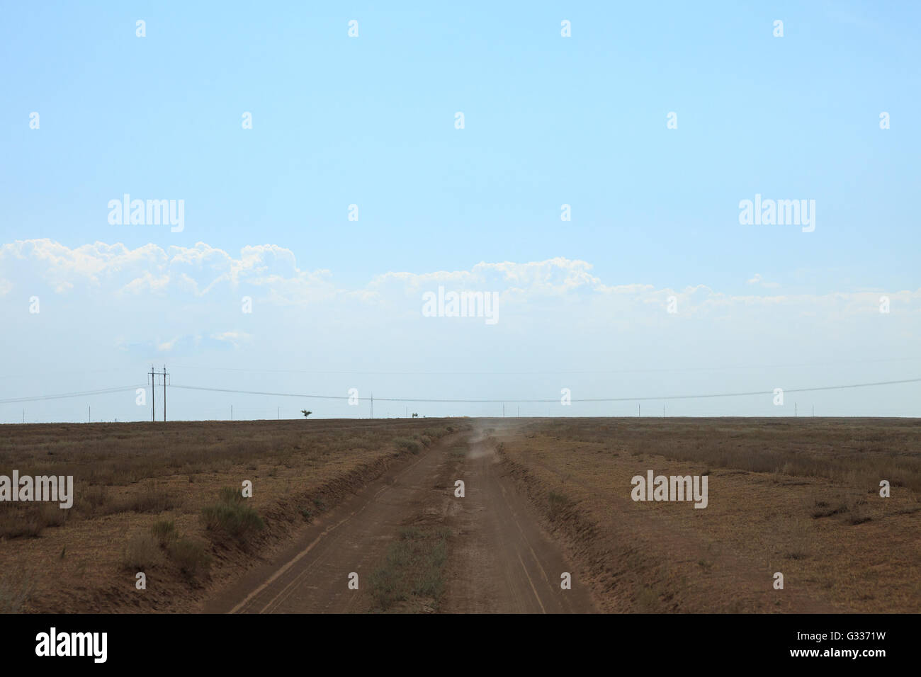 Sandy country road in the salt desert landscape on a hot summer day ...