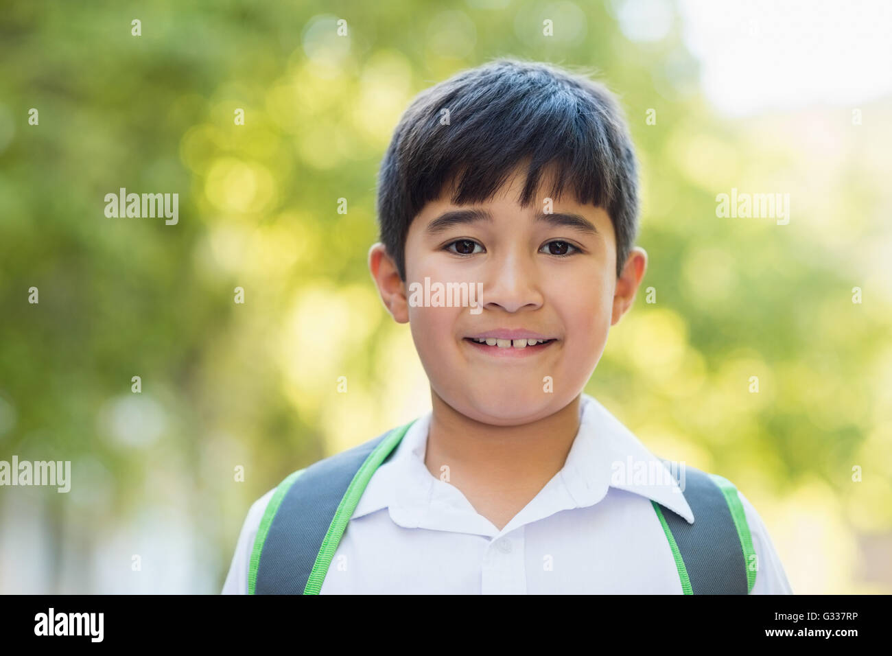 Happy schoolboy standing in campus Stock Photo - Alamy