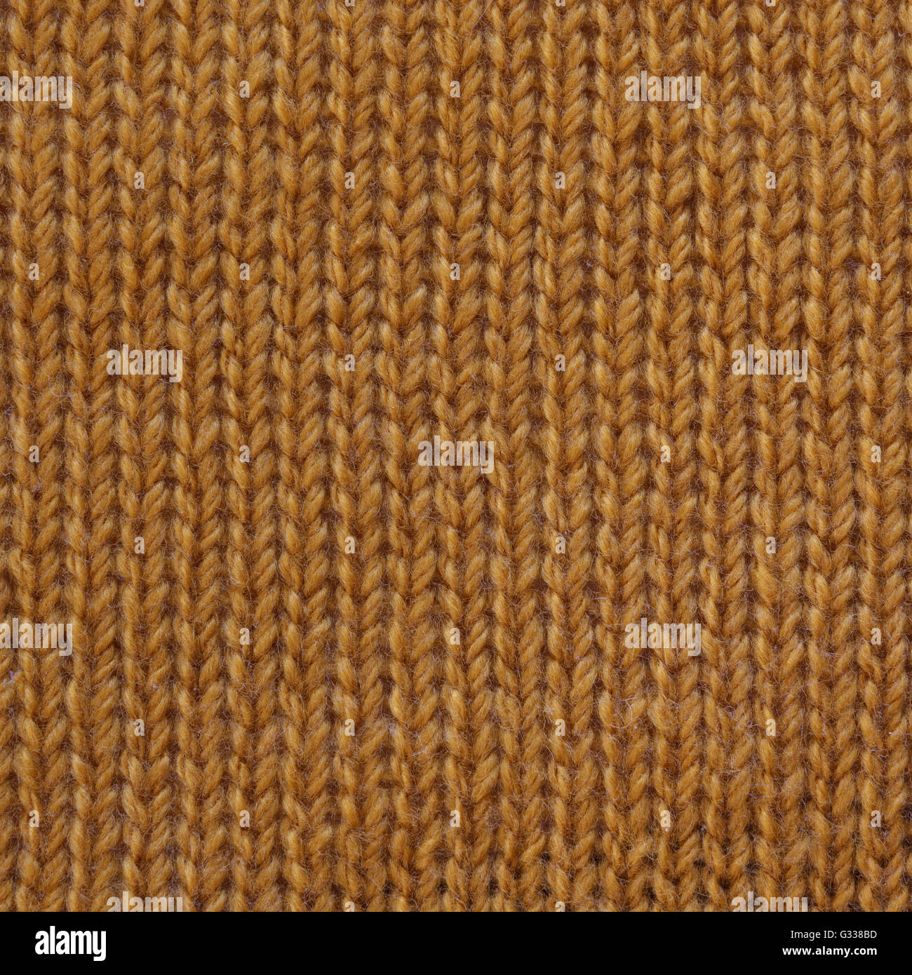Pastel yellow wool knitted fabric texture. Close up fragment of the top ...