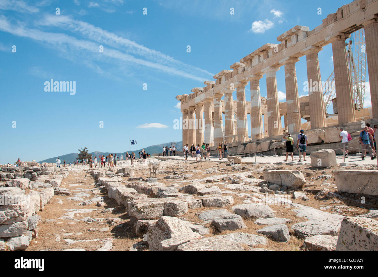 The Parthenon in the Acropolis Tall Columns tourists visiting blue clear sky, Athens Greece ...