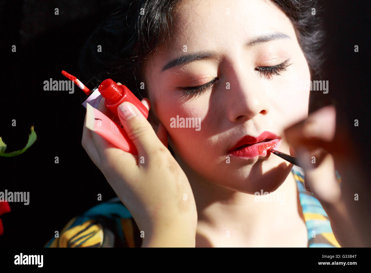 Asian girls are making up face feature Stock Photo - Alamy