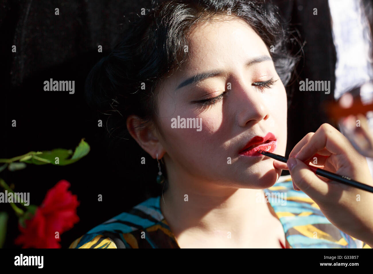 Asian girls are making up face feature Stock Photo - Alamy
