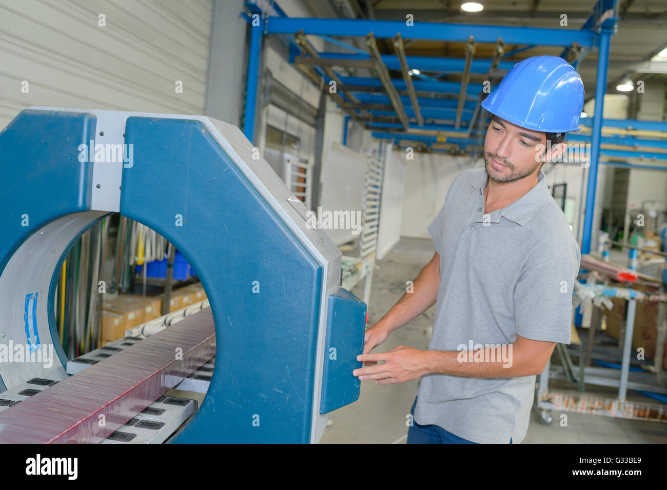 Factory worker controlling machine Stock Photo - Alamy