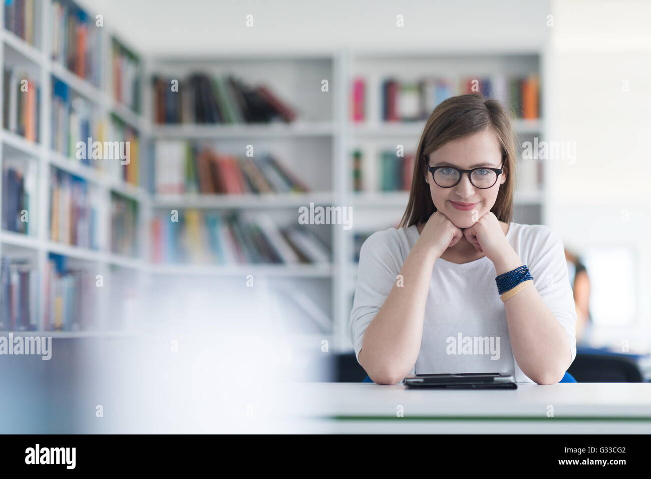 female student study in school library, using tablet and searching for ...
