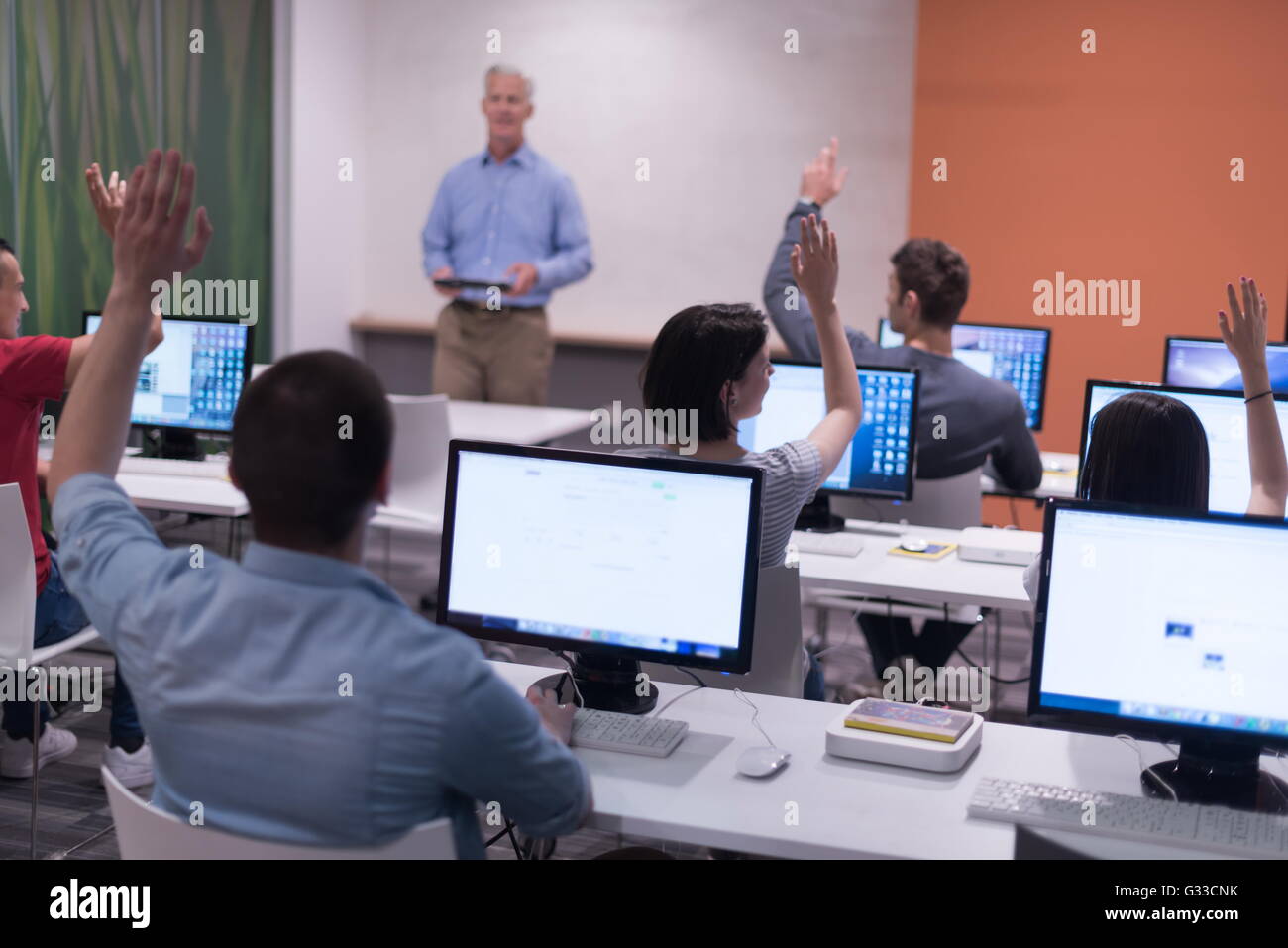 handsome mature teacher and students in computer lab classroom Stock Photo - Alamy