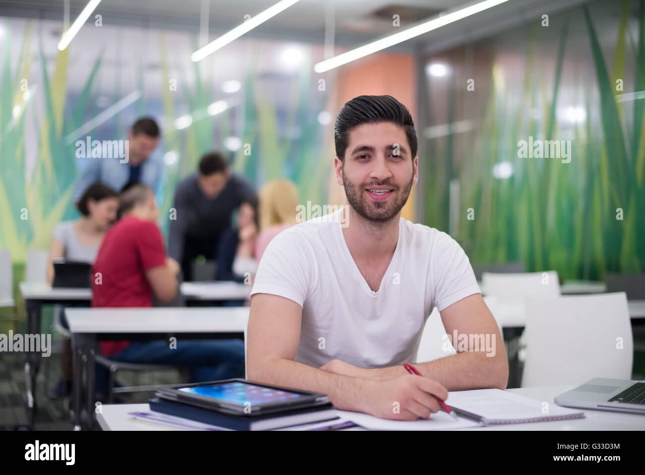 male student in classroom working homework and learning with laptop ...