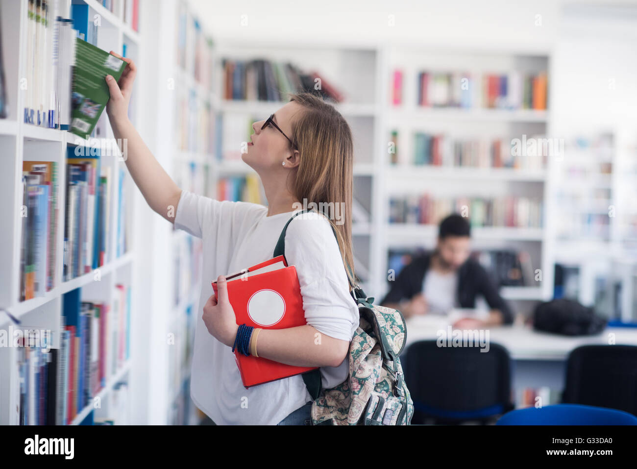 smart looking famale student girl in collage school library selecting ...