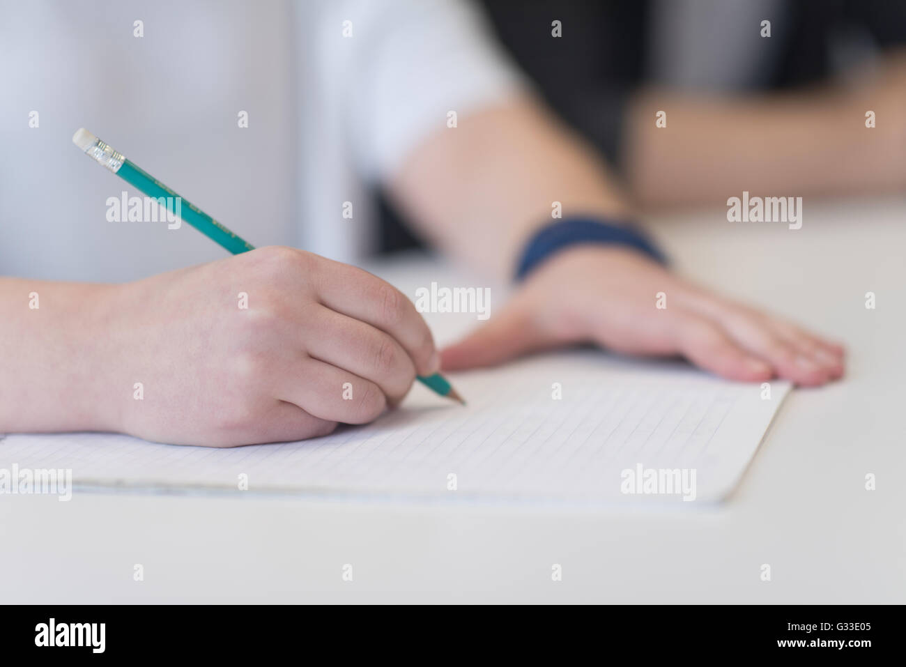 male student taking notes in classroom. business education concept ...