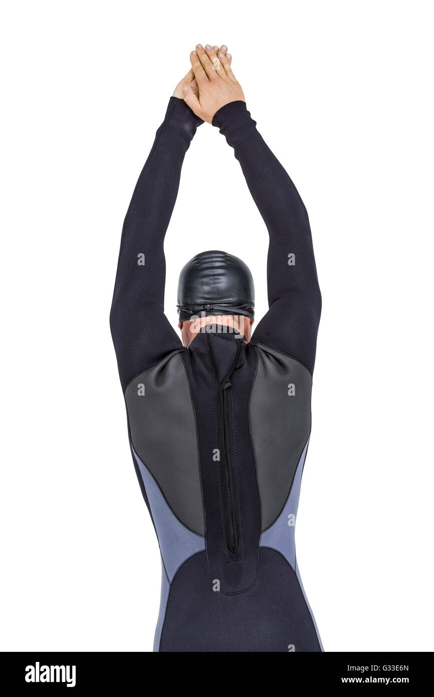 Rear view of swimmer in wetsuit while diving Stock Photo - Alamy