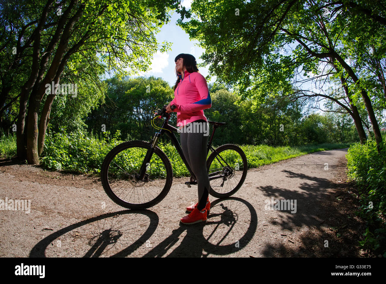 Young woman having fun riding a bicycle in the park Stock Photo - Alamy