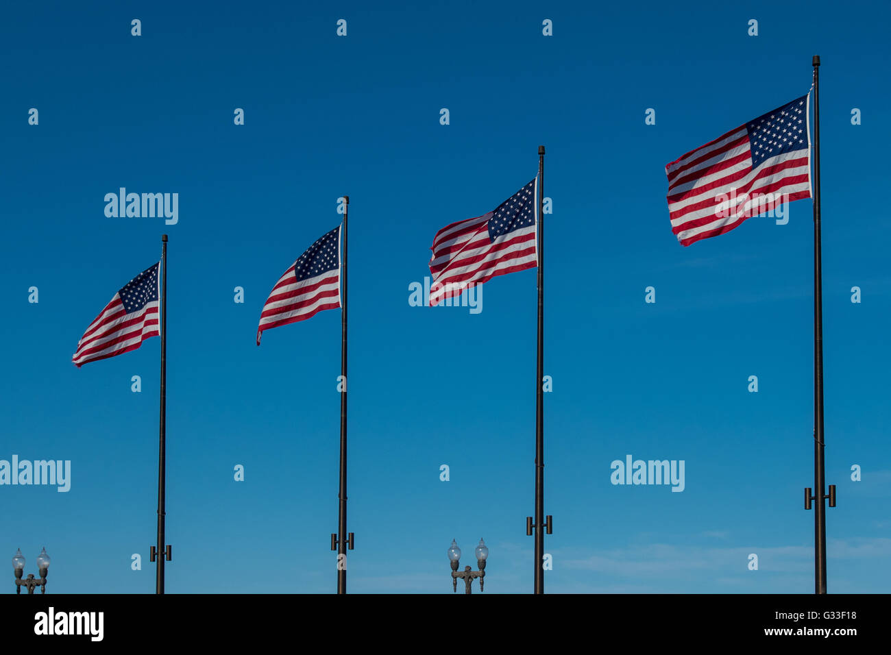 Line of Four American Flags Waving on Blue Sky in downtown Chicago ...