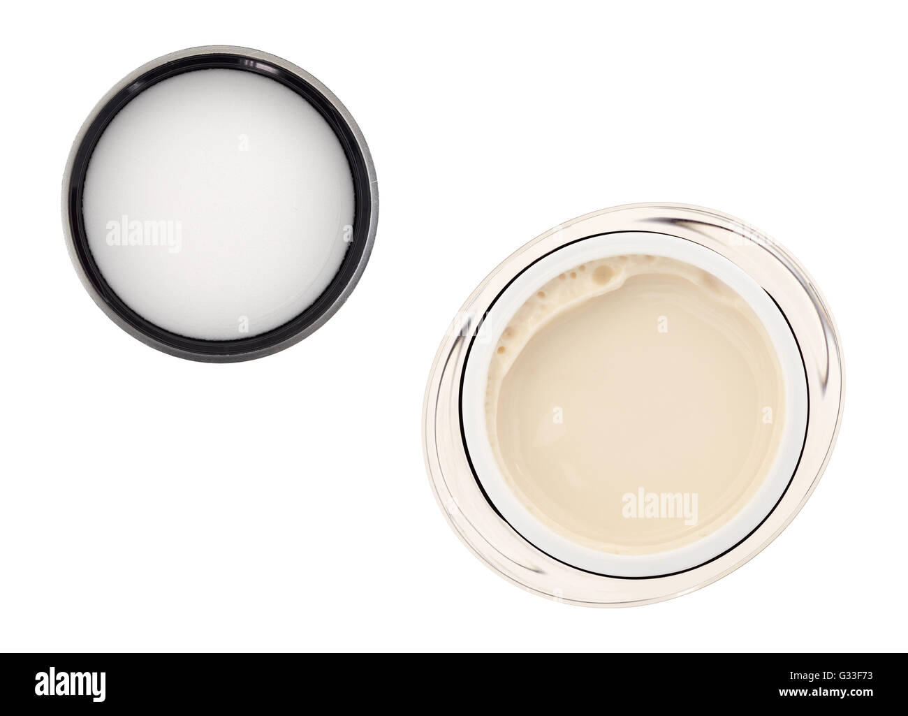 Top view of a jar of moisturizing face cream with a lid to the side ...