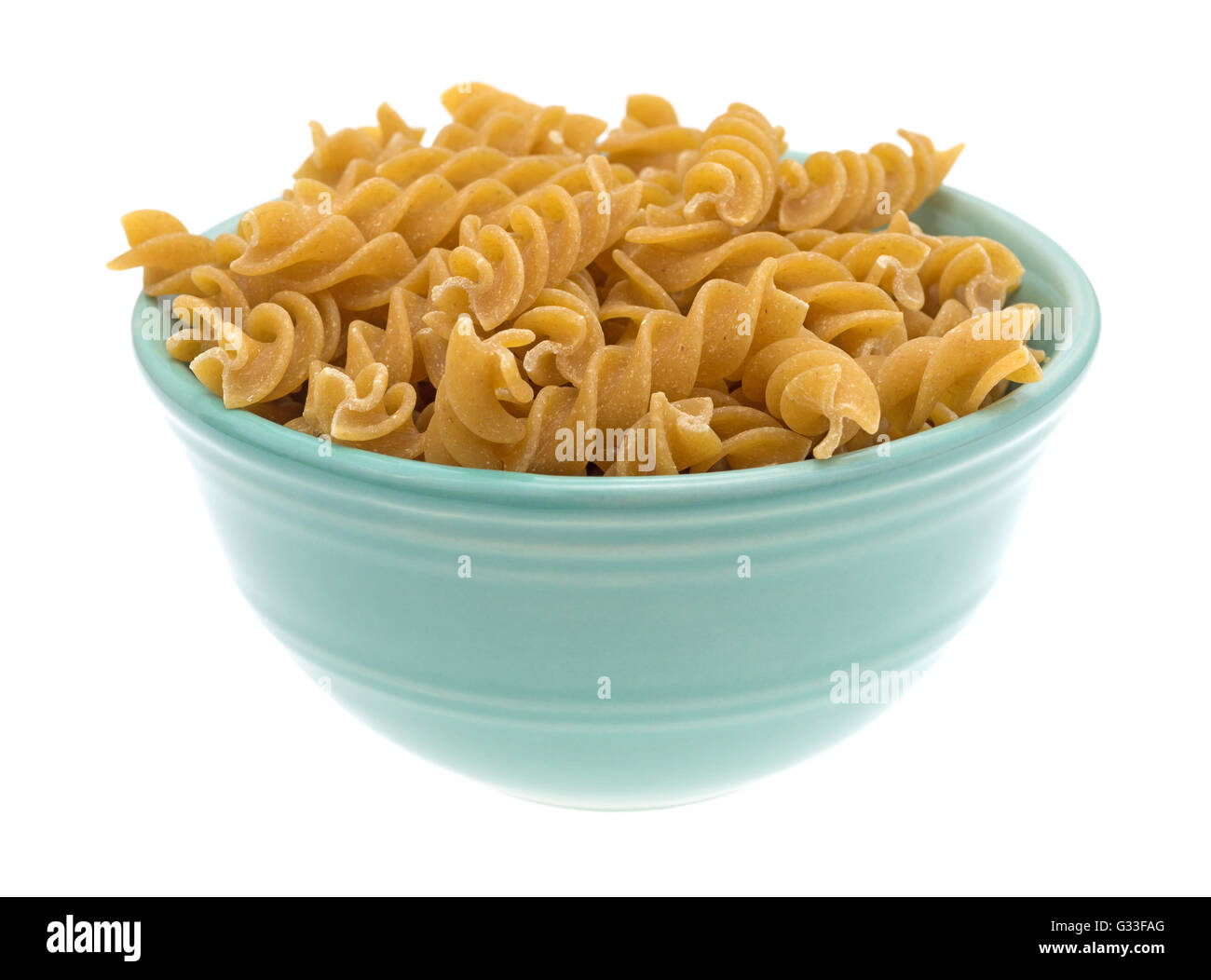 A small bowl filled with fusilli whole wheat organic pasta isolated on ...