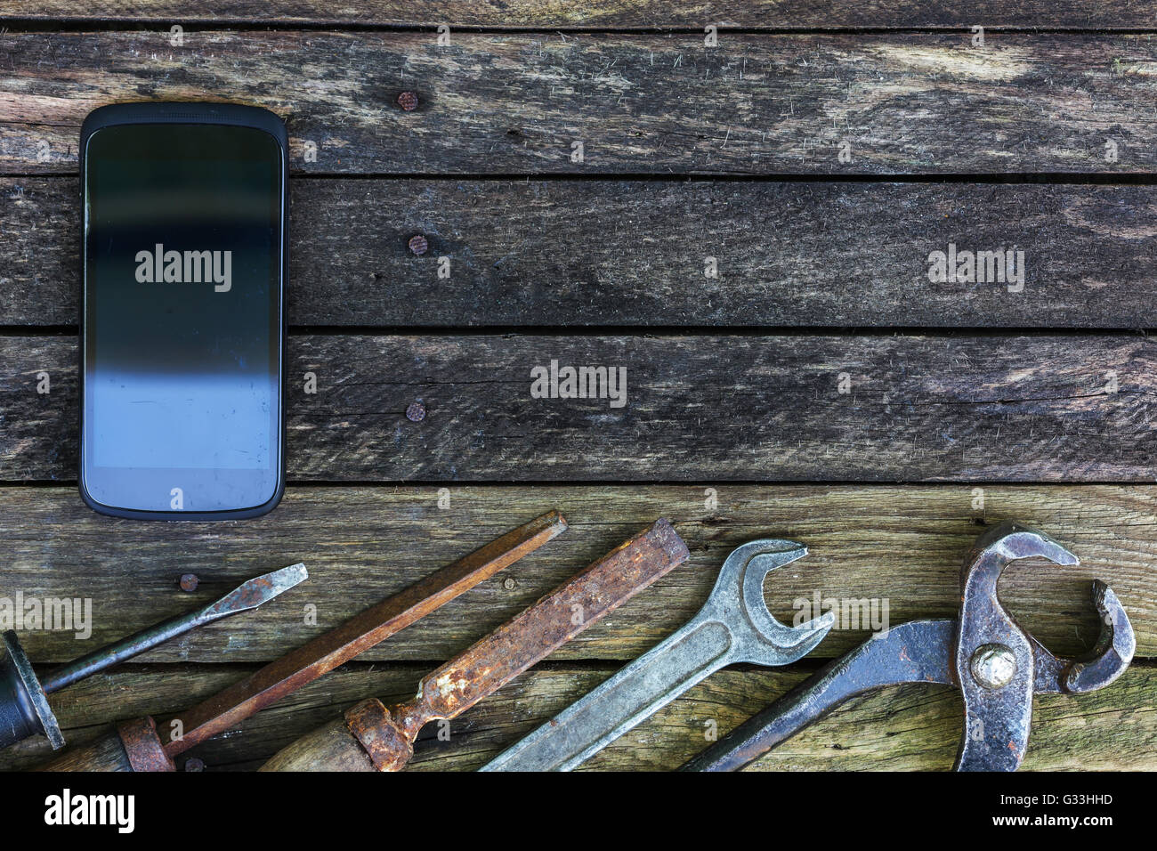 Repair phone using tools. Old workshop with new technologies. The ...