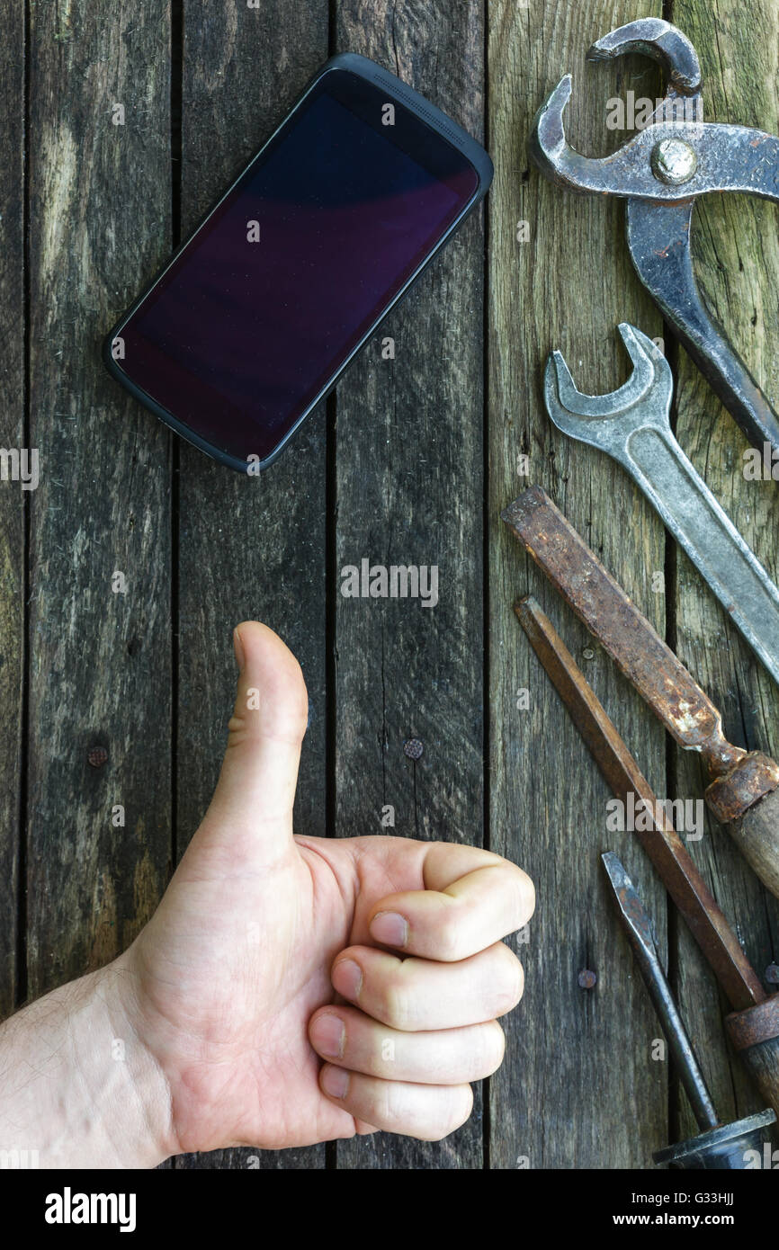 Repair phone using tools. Old workshop with new technologies. The ...