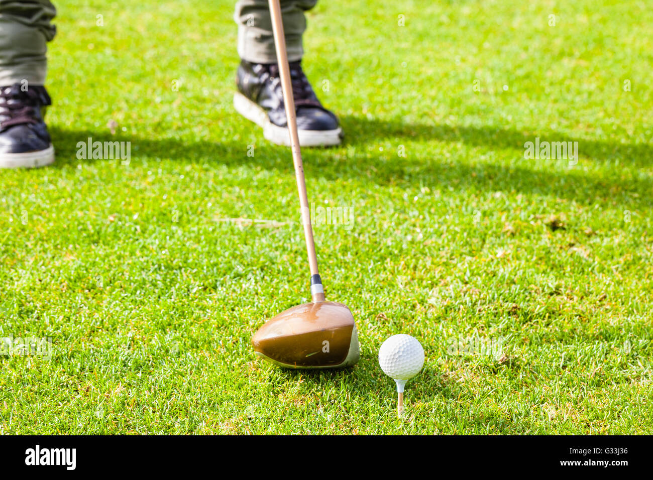 detail of a driver club and a golf ball on a golf course Stock Photo ...
