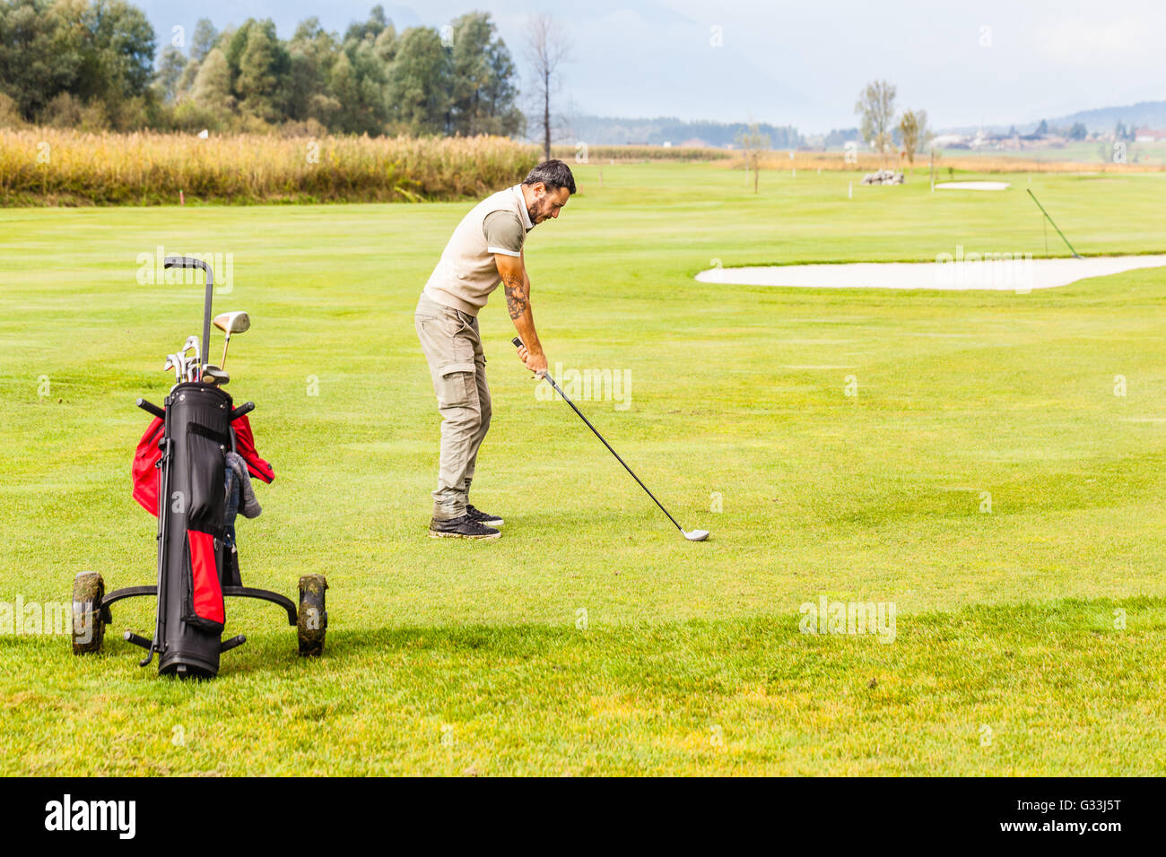 a golf player making a swing on a vibrant beautiful golf course Stock ...