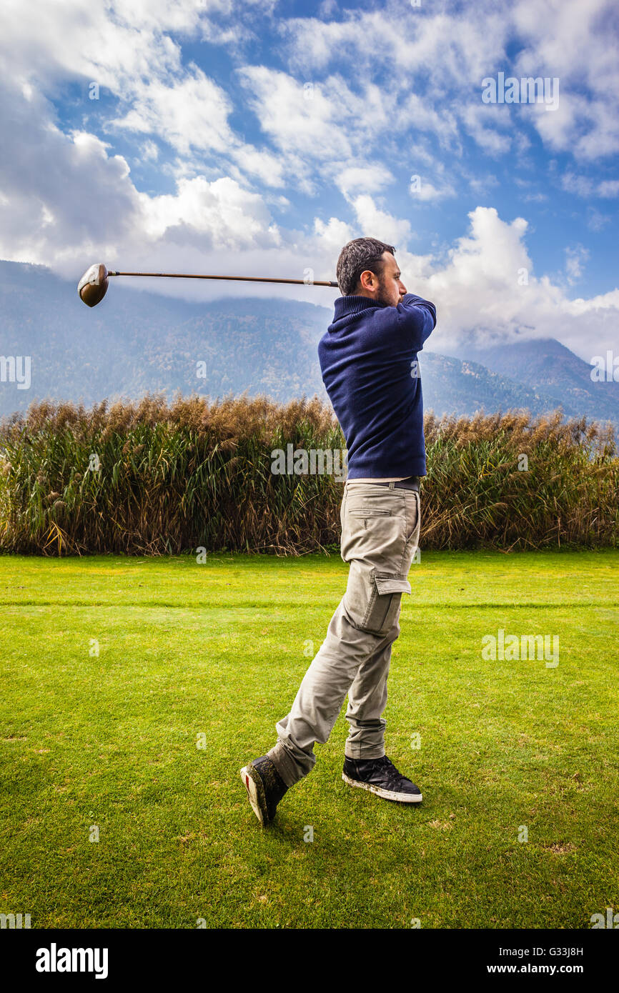 a golf player making a swing on a vibrant beautiful golf course Stock ...