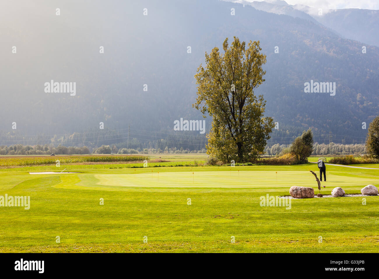 the beautiful vibrant putting green of an Austrian golf course on a ...