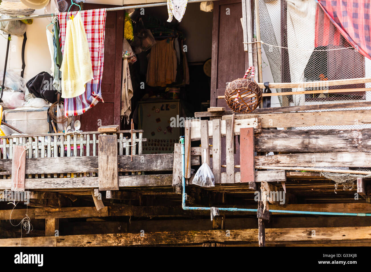 Wooden slums on stilts on the riverside of Chao Praya River in Bangkok ...