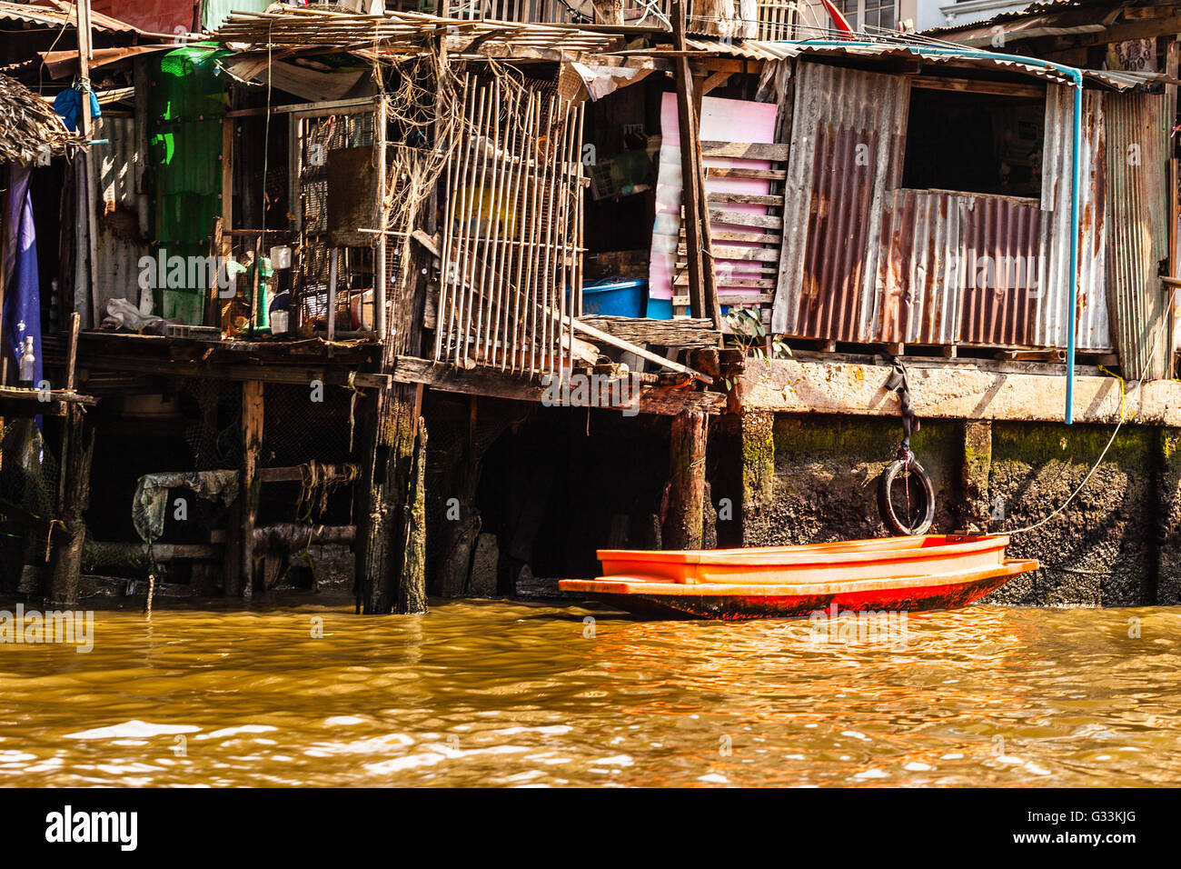 Wooden slums on stilts on the riverside of Chao Praya River in Bangkok ...
